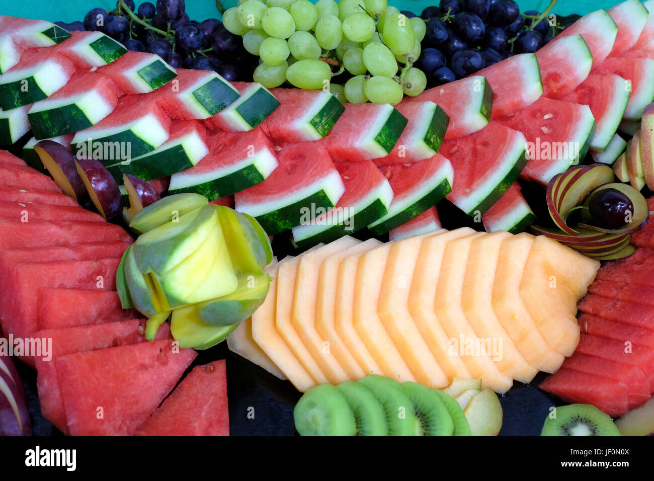 Slices of watermelon, melon, kiwis and grapes Stock Photo - Alamy