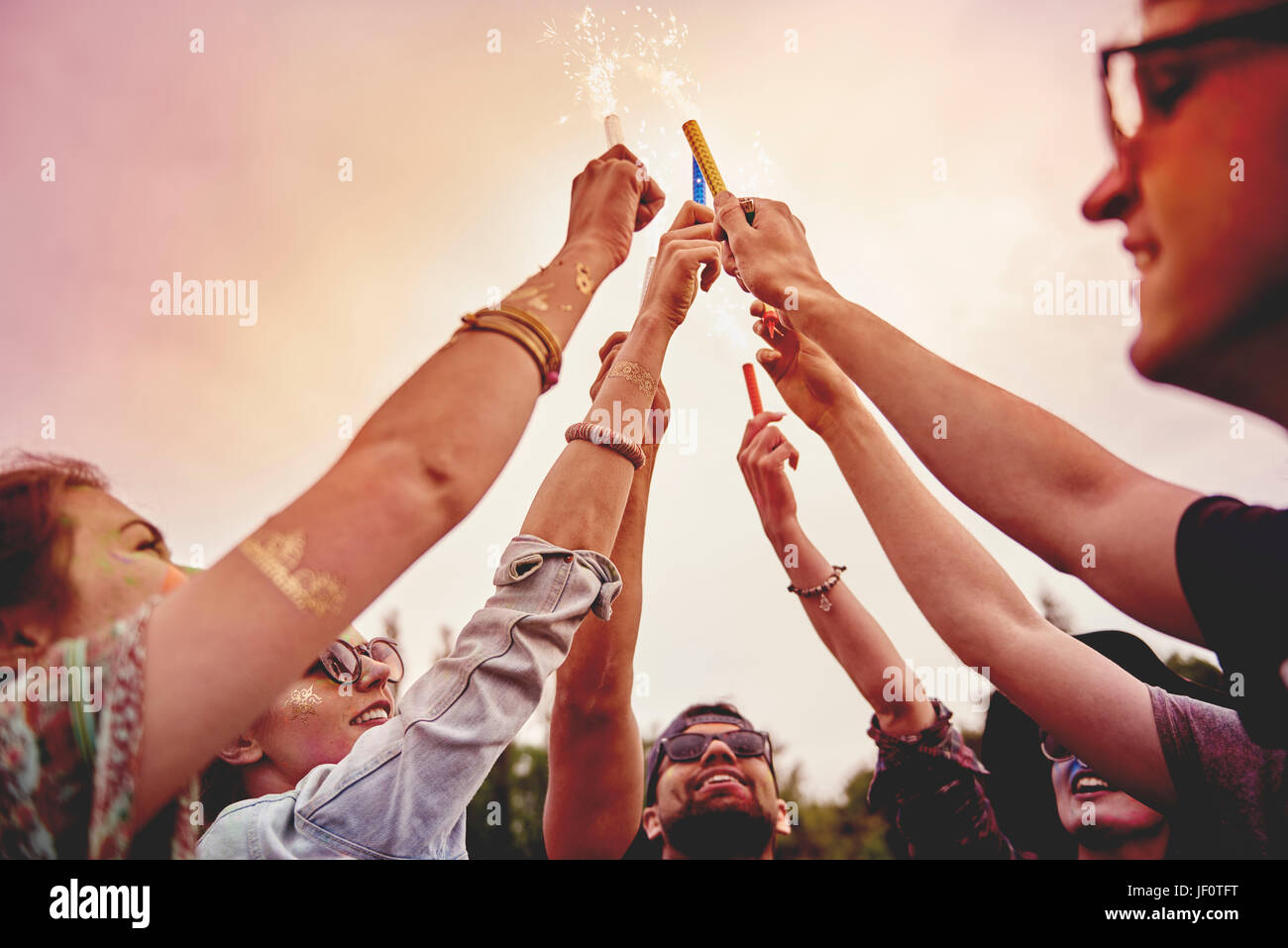 Group of friends with fireworks in hands Stock Photo - Alamy