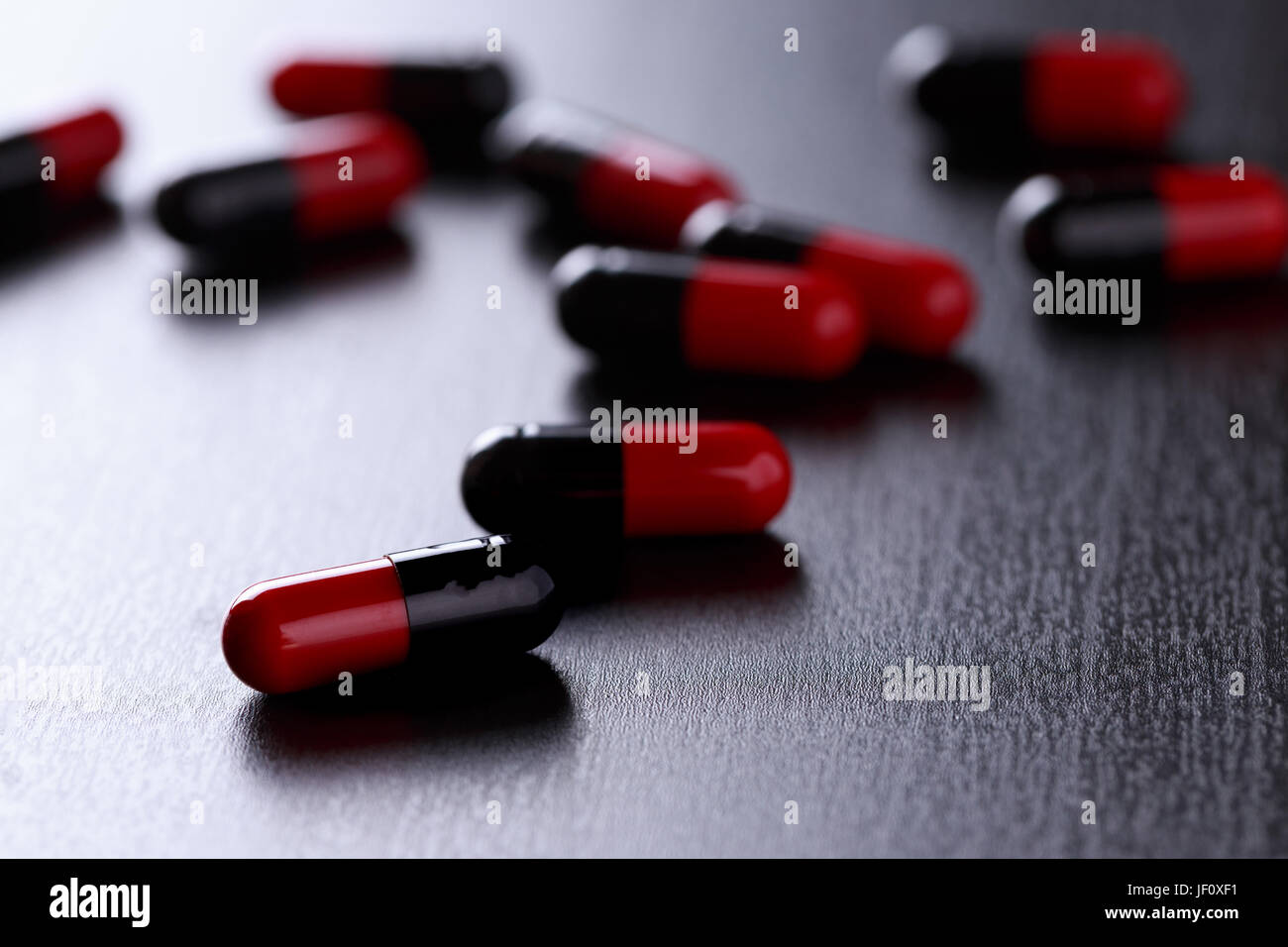 Close-up Pills red anf black on Tablets. Medical background Assorted ...