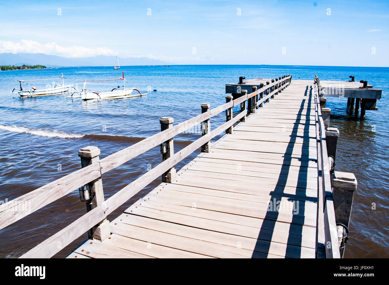 A wood pontoon access to paradise beach of a tropical island Stock ...