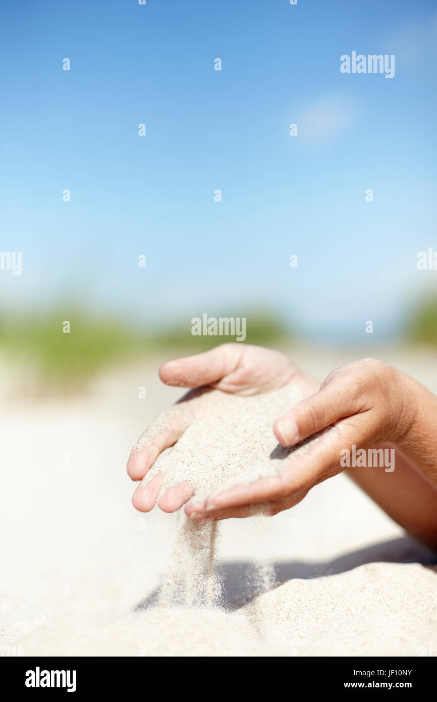 Close-up of persons hands spilling sand Stock Photo - Alamy