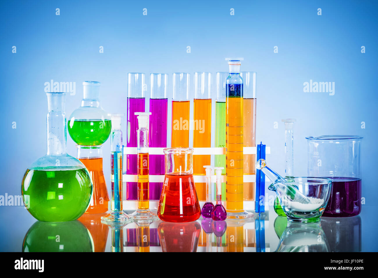 Laboratory glass filled with colorful substances. Chemical liquid ...