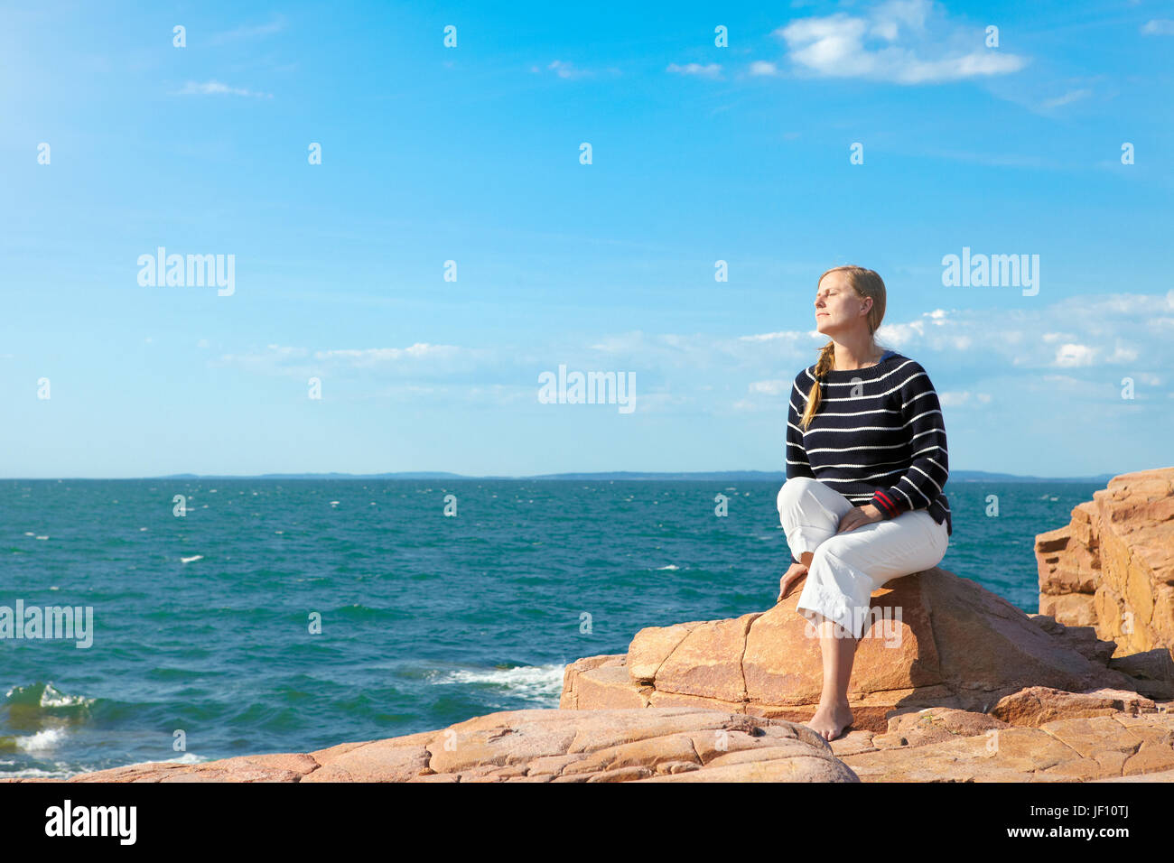 Woman relaxing at sea Stock Photo - Alamy