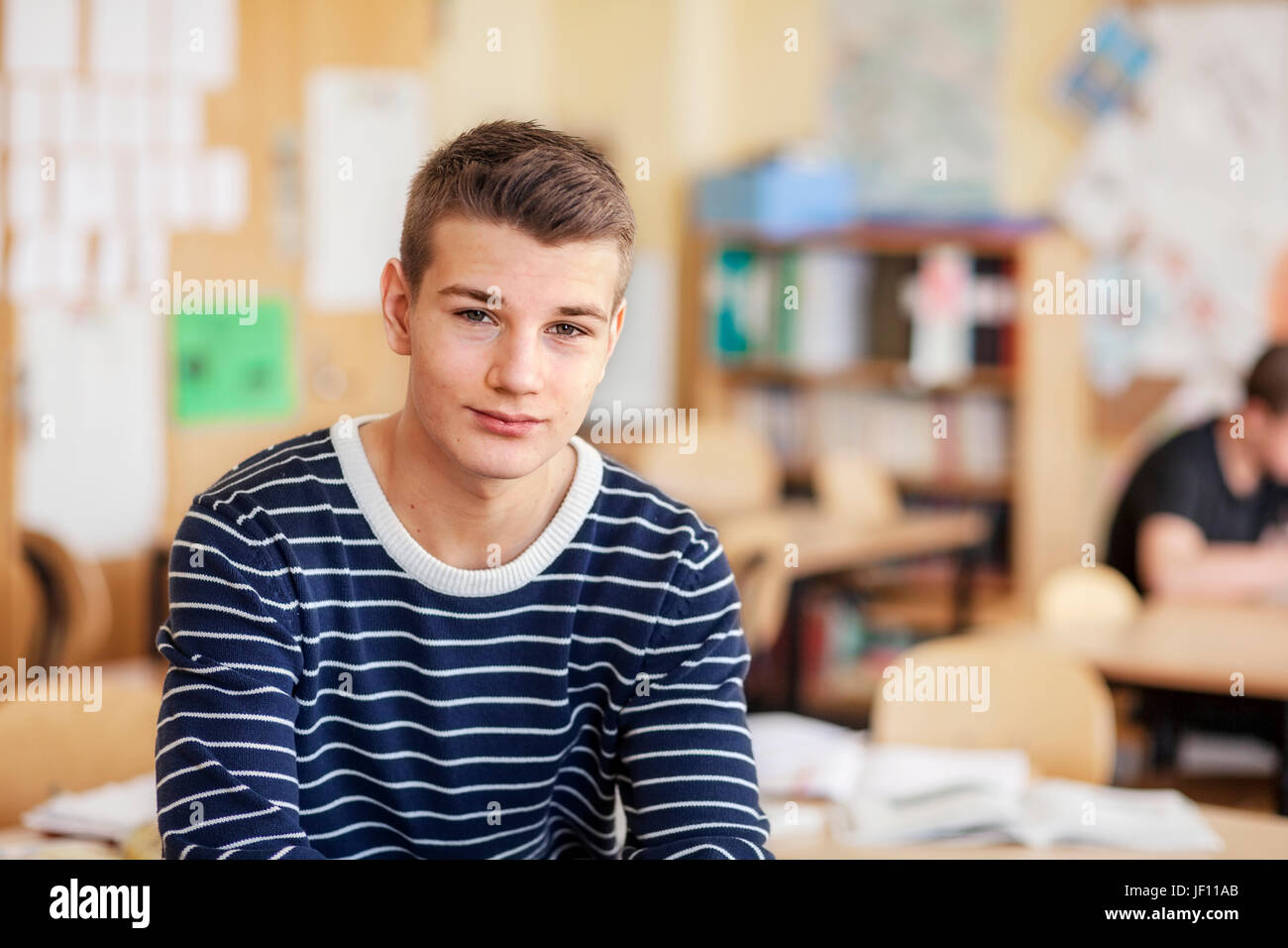 Teenage boy in classroom Stock Photo - Alamy
