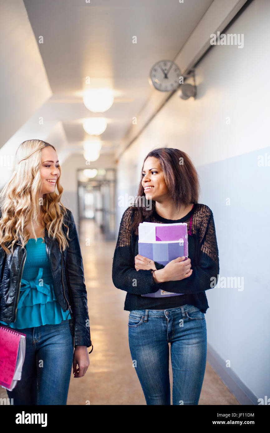 Teenage friends standing on corridor Stock Photo - Alamy