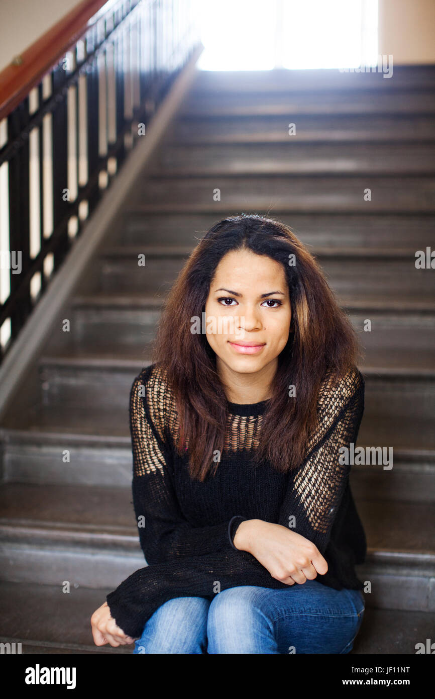 Teenage girl sitting on stairs Stock Photo - Alamy