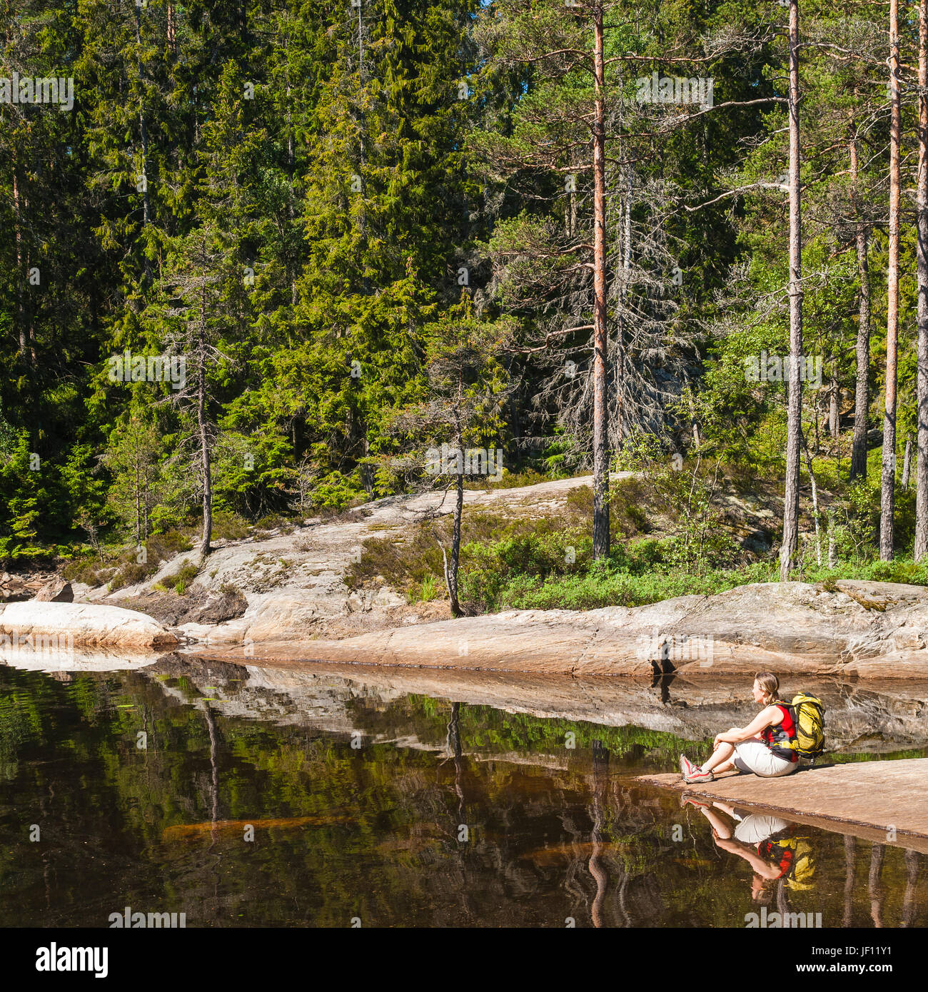 Woman looking at lake Stock Photo - Alamy