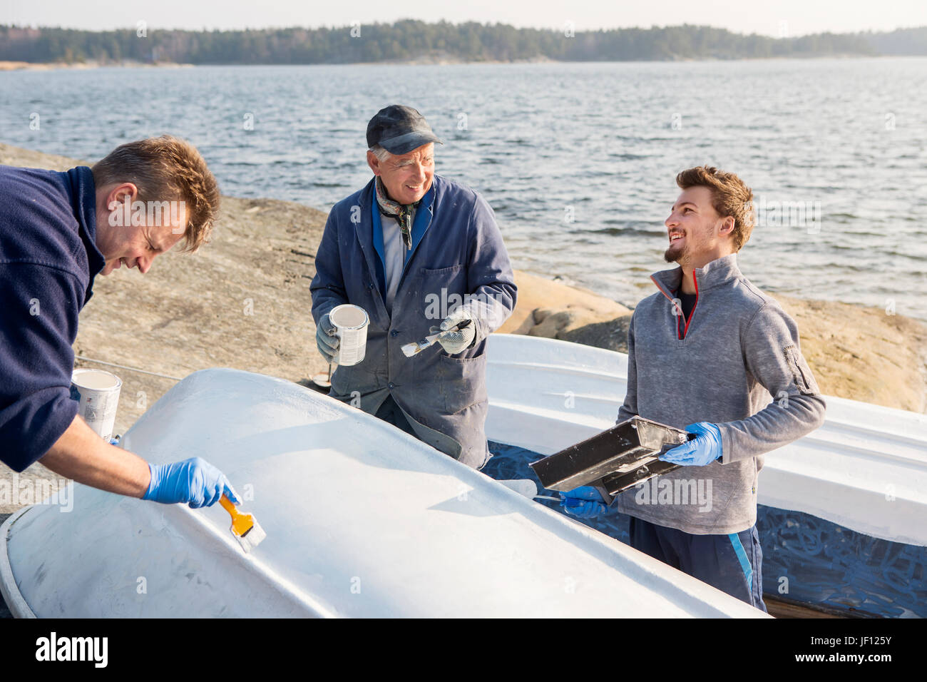 Men painting boat Stock Photo - Alamy