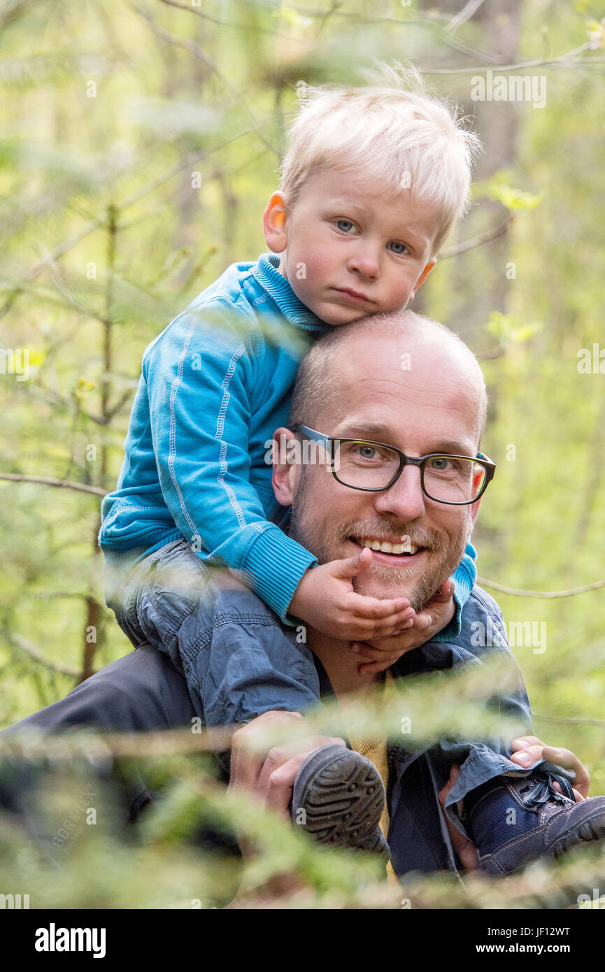 Father walking with son in forest Stock Photo - Alamy