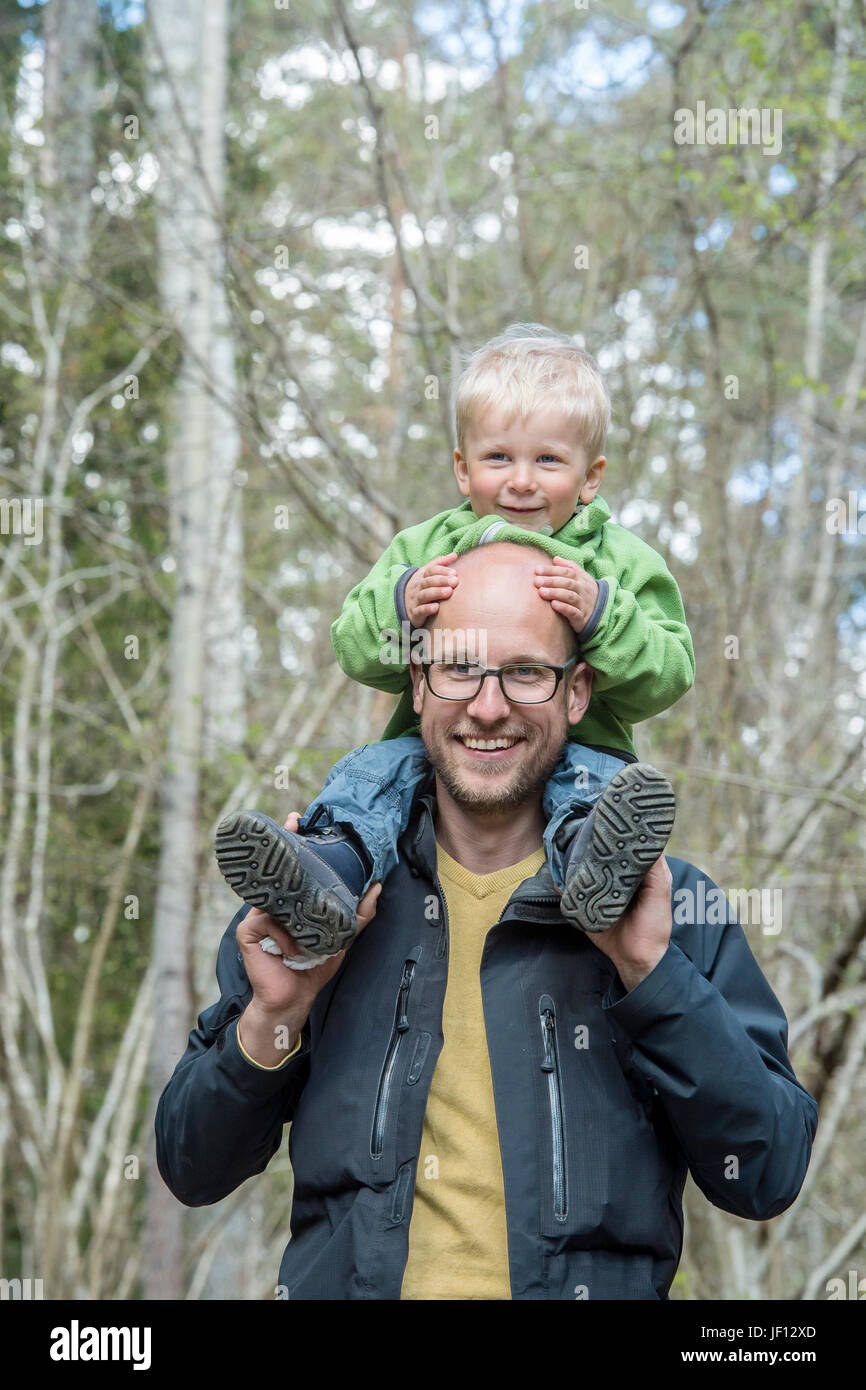 Father walking with son in forest Stock Photo - Alamy
