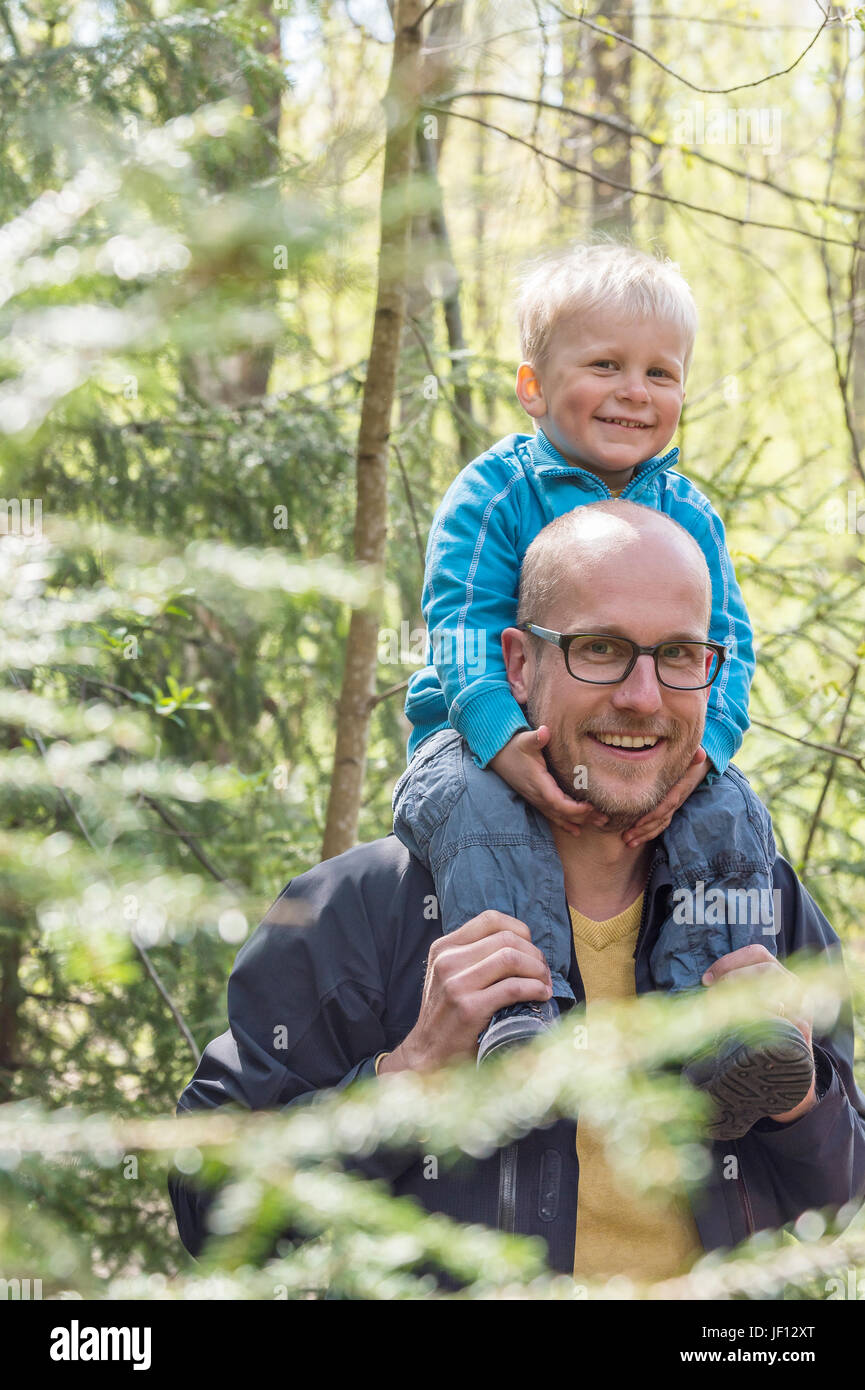 Father walking with son in forest Stock Photo - Alamy