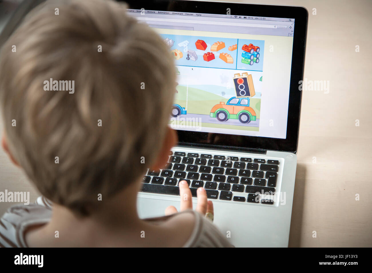 Boy playing laptop Stock Photo - Alamy
