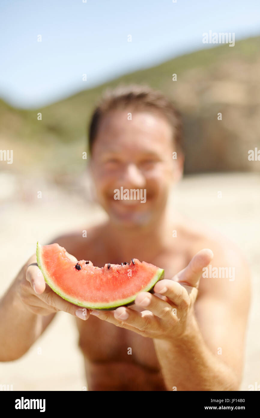 Man holding watermelon Stock Photo - Alamy