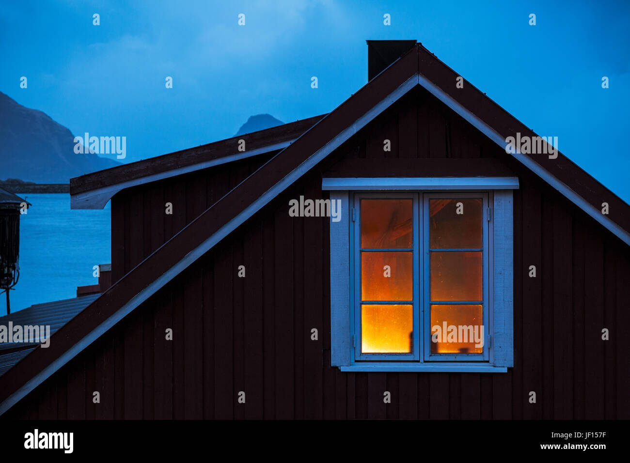 Illuminated window at dusk Stock Photo - Alamy