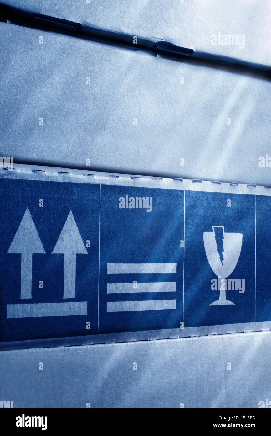 close up warning signs on cardboard package Stock Photo - Alamy