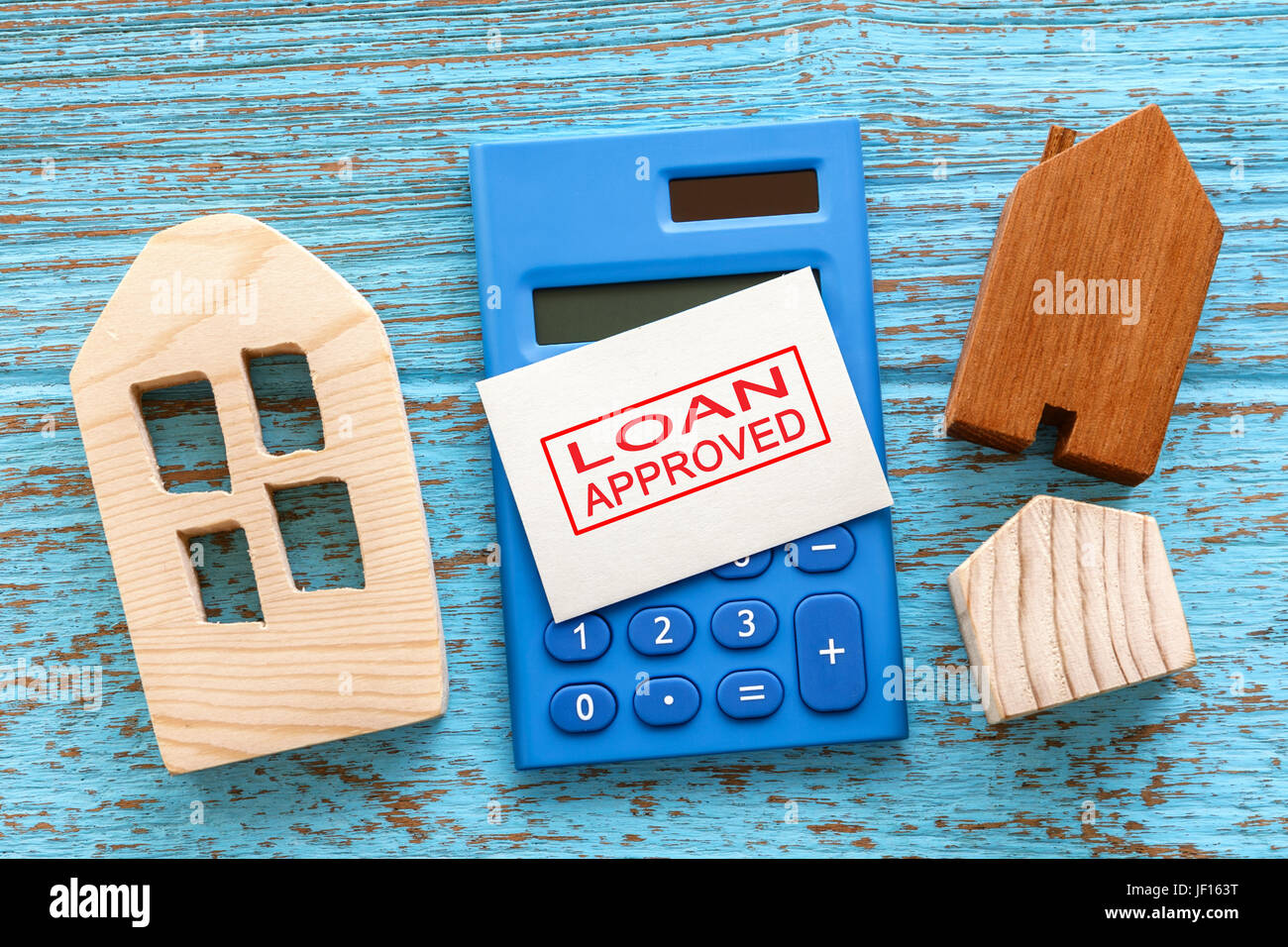 Wood house and calculator with loan approved label for housing loan ...