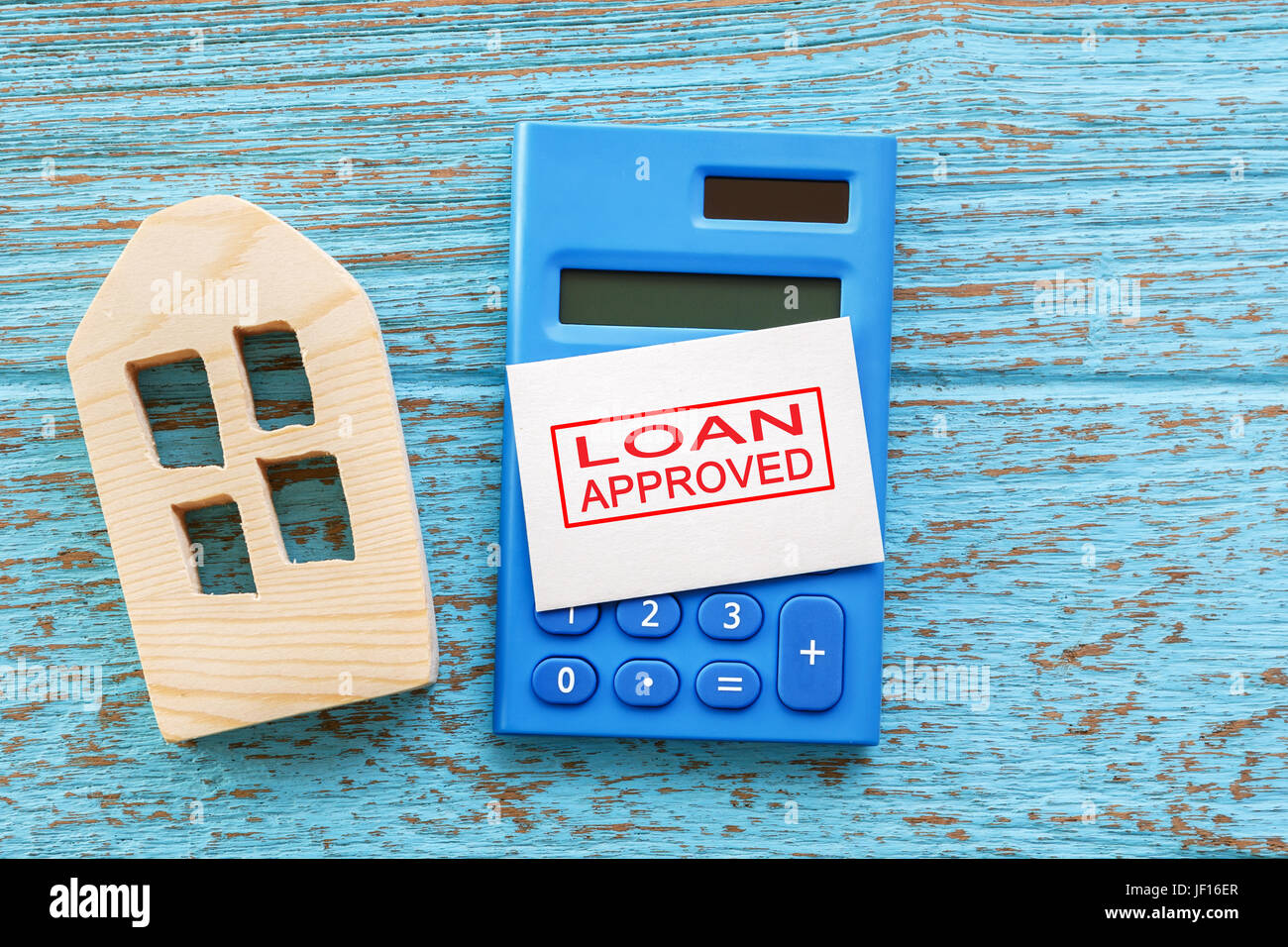 Wood house and calculator with loan approved label for housing loan ...