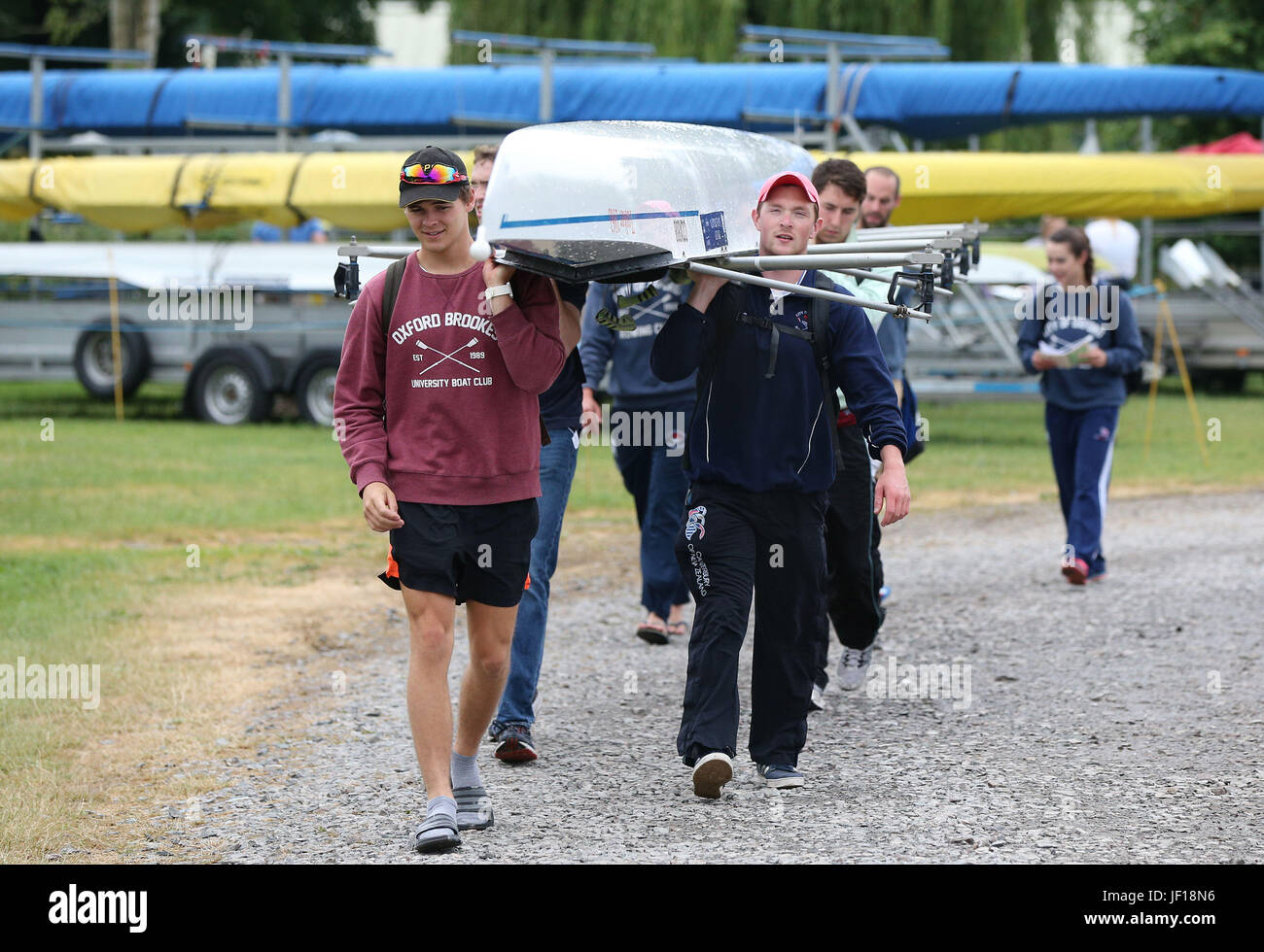 Members of the Oxford Brookes University rowing crew bring their boat ...
