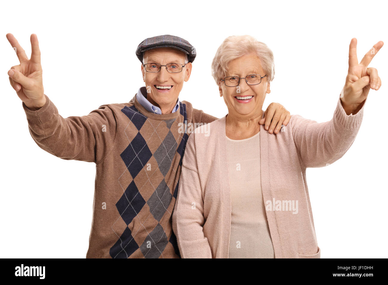 Joyful senior couple making victory signs isolated on white background ...