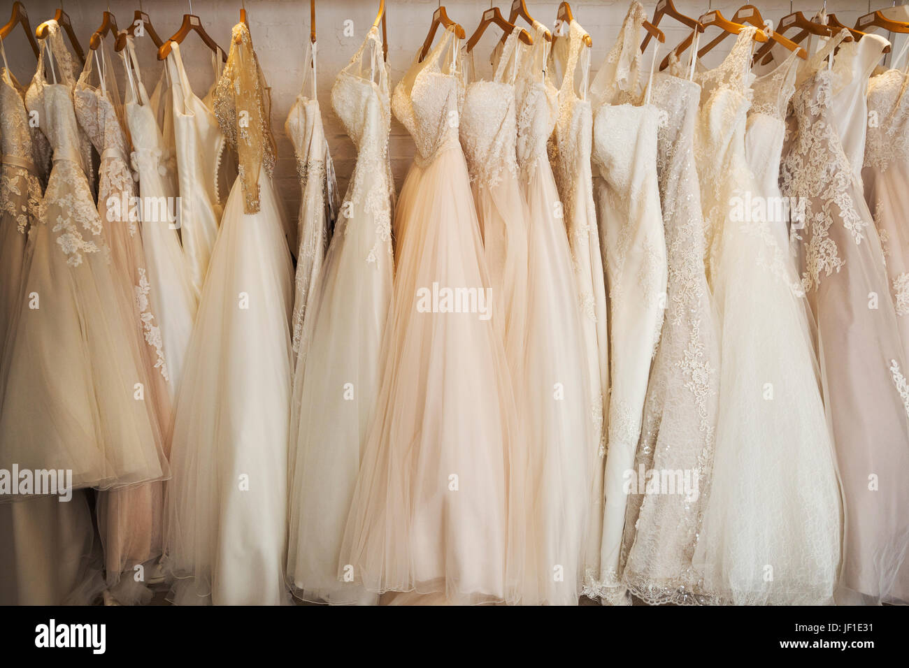 Rows of wedding dresses on display in a specialist wedding dress shop ...
