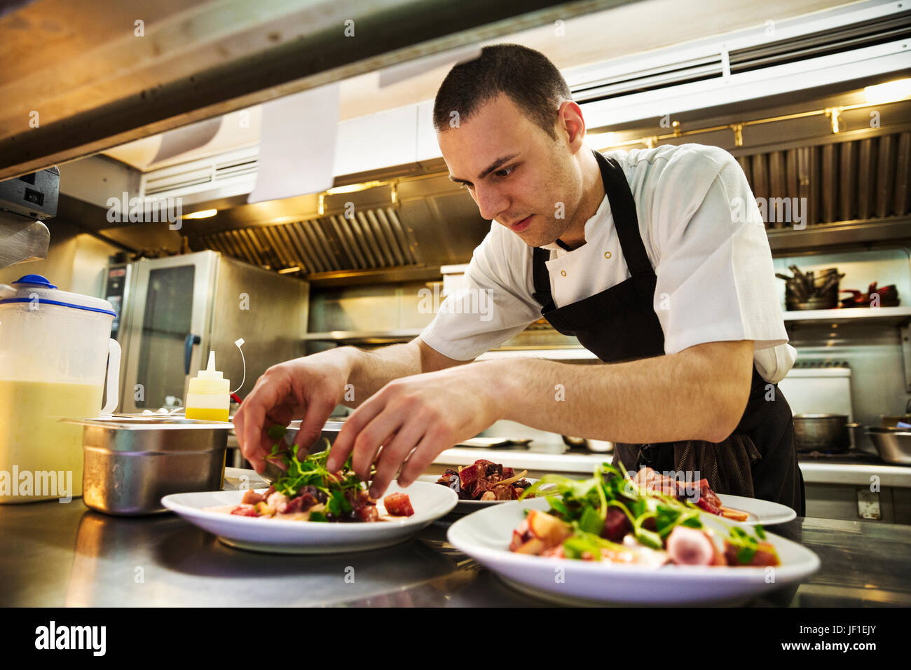 Adding the garnish hi-res stock photography and images - Alamy