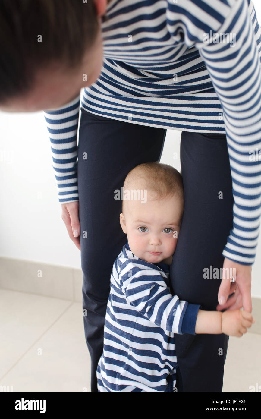 Baby embracing mother Stock Photo - Alamy