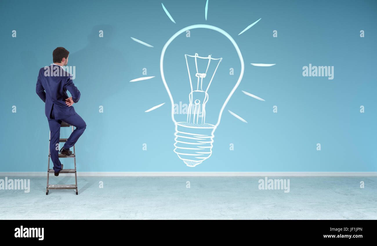 Businessman in modern interior watching a lightbulb on a wall 3D ...