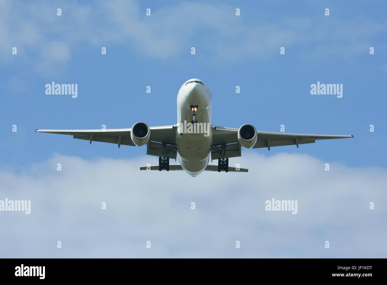 Font view Passenger Airplane Landing with cloud and blue sky Stock ...