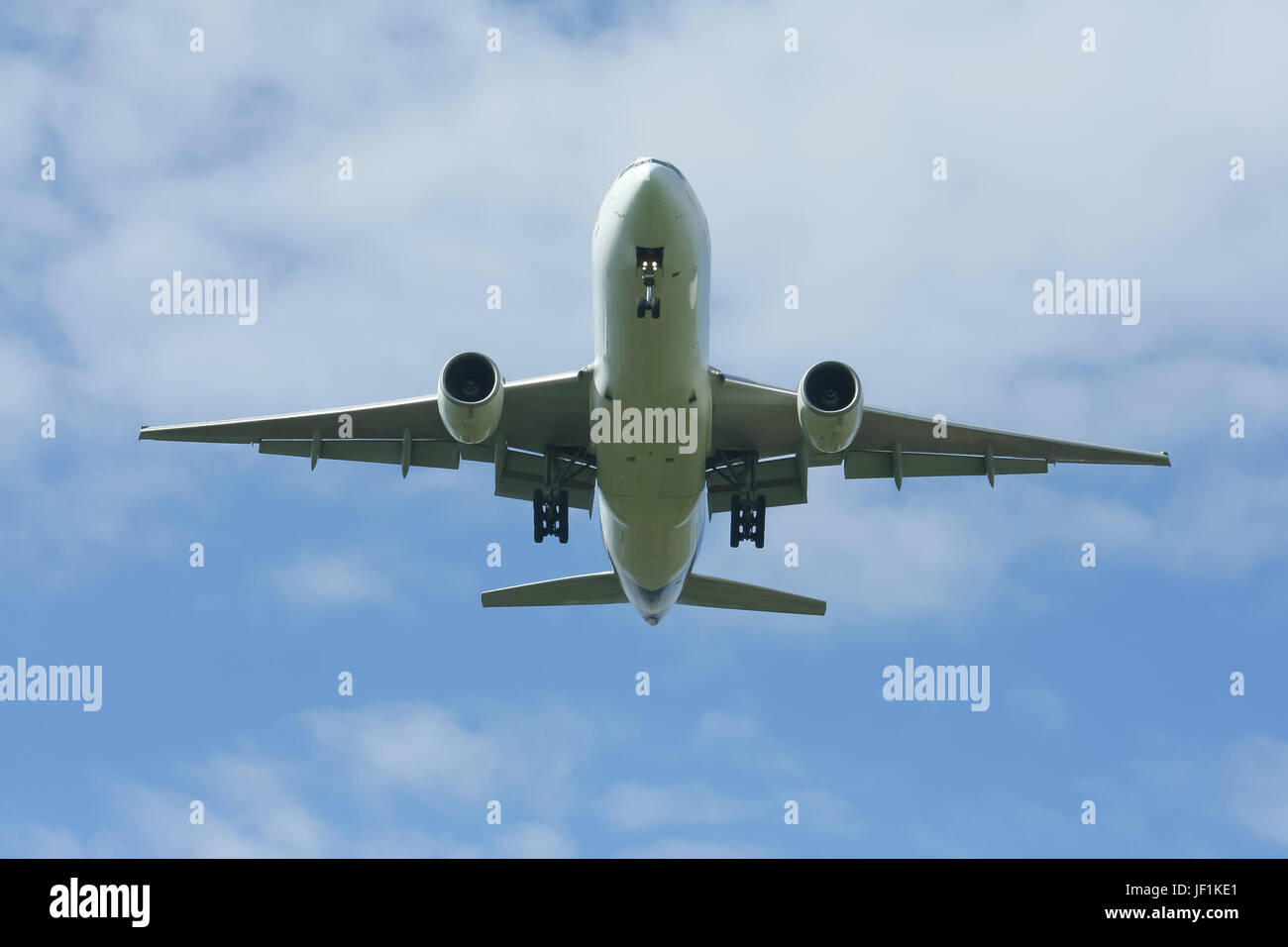 Font view Passenger Airplane Landing with cloud and blue sky Stock ...