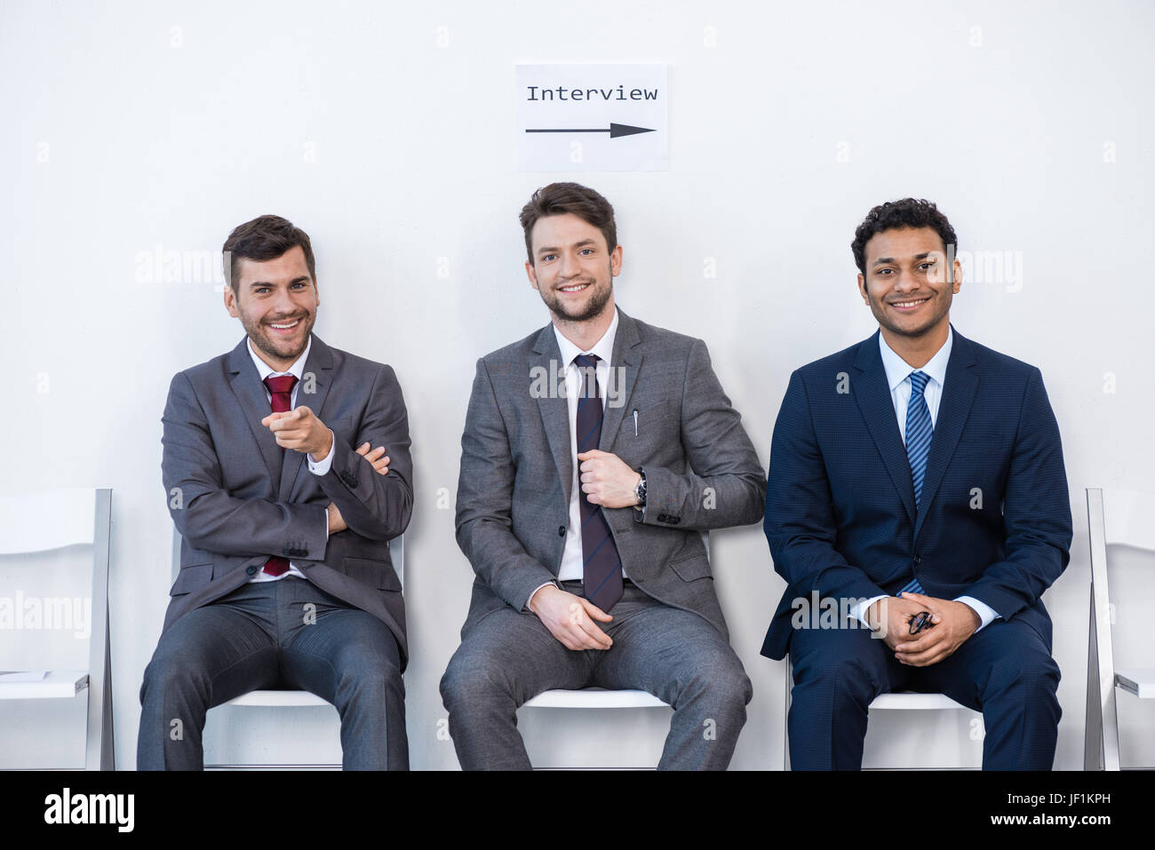 businessmen sitting in queue and waiting for interview in office ...