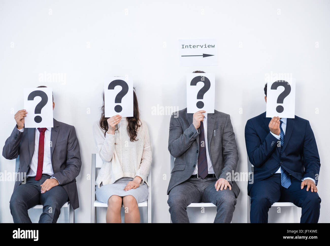 businesspeople sitting in queue and waiting for interview, holding ...