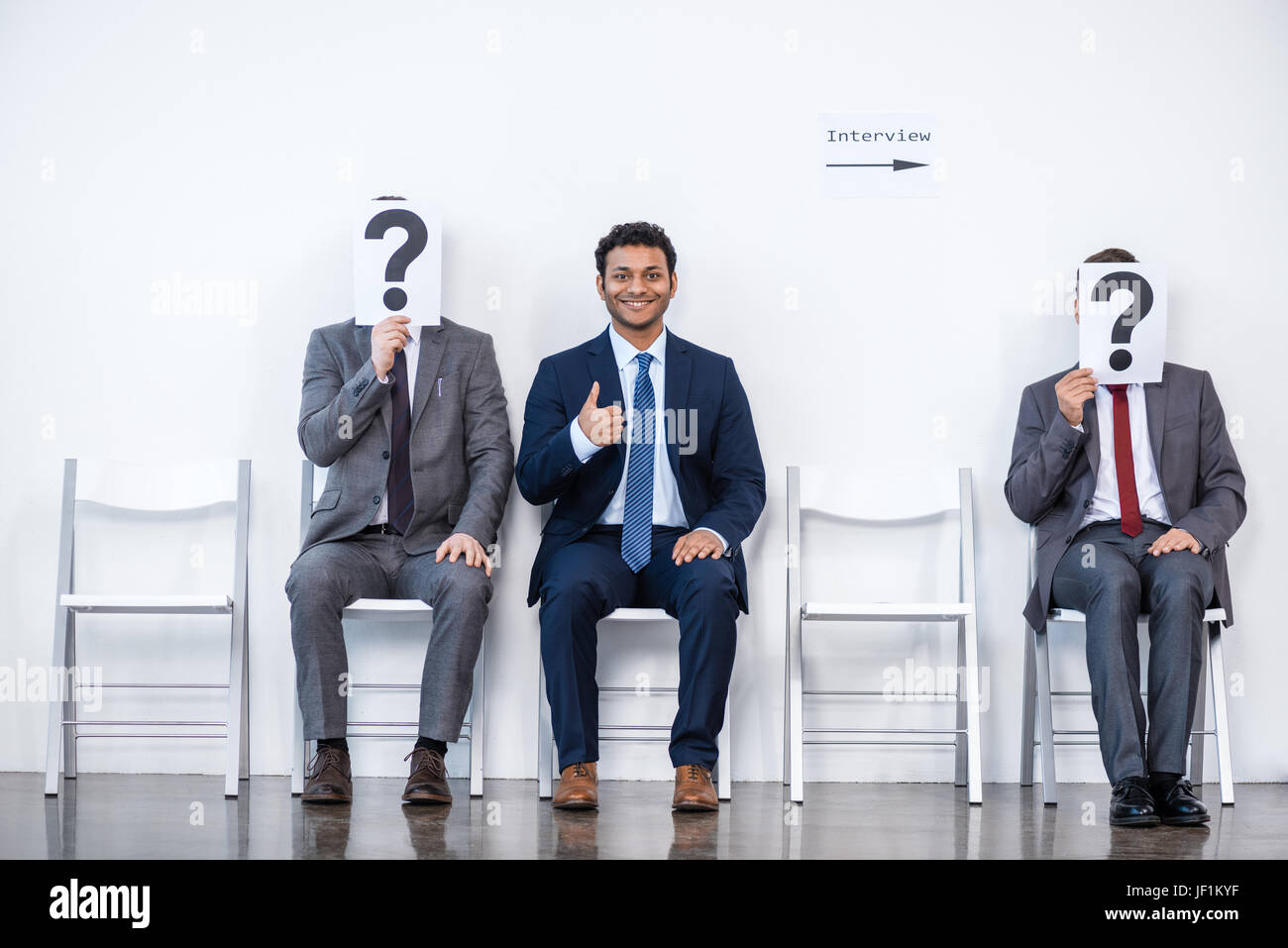 businesspeople sitting in queue and waiting for interview, holding ...