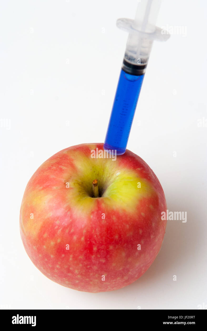 Gm food concept, additives and chemicals being injected into fruit ...