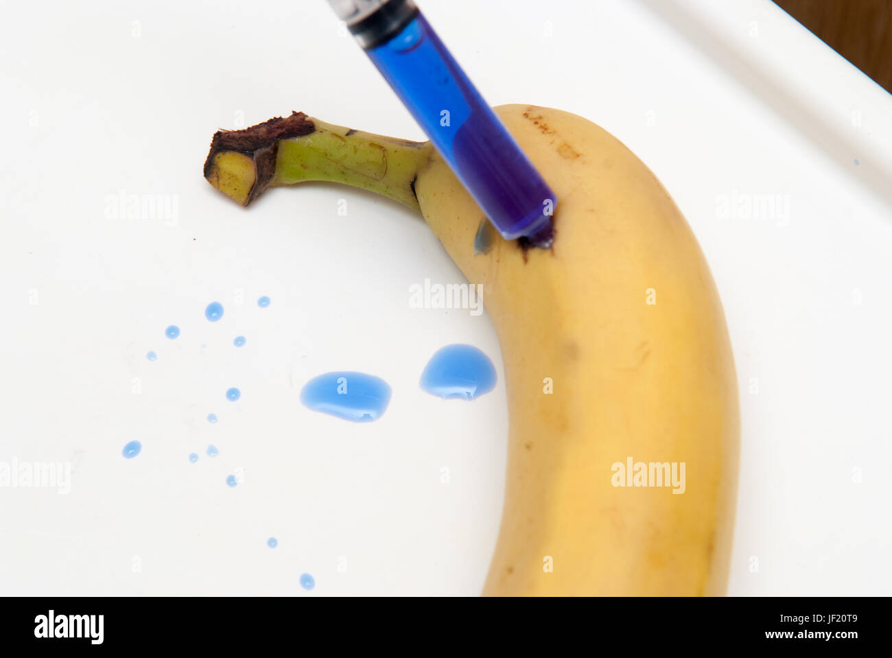 Gm food concept, additives and chemicals being injected into fruit ...