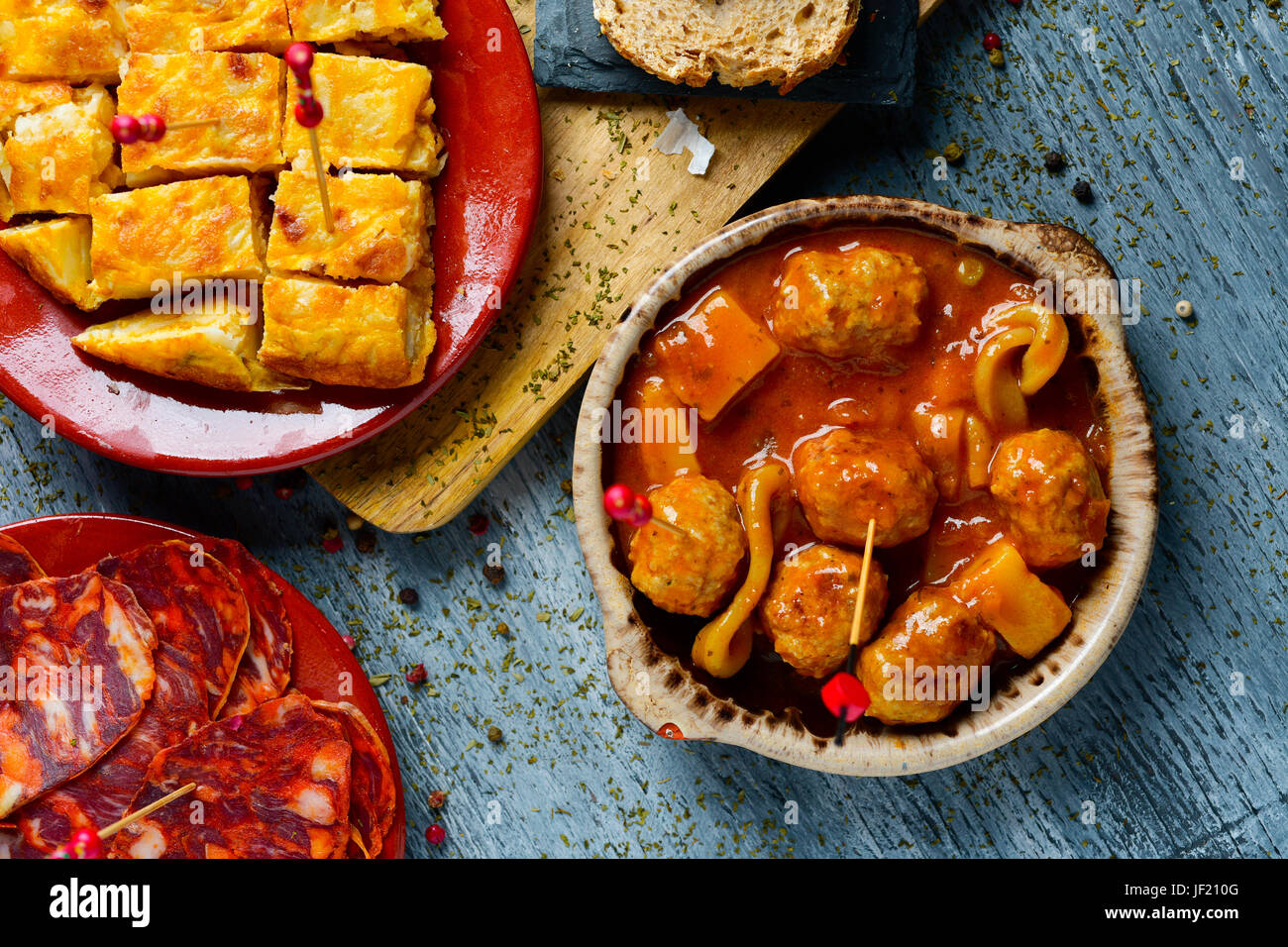 high-angle shot of some plates with different spanish cold meats and ...