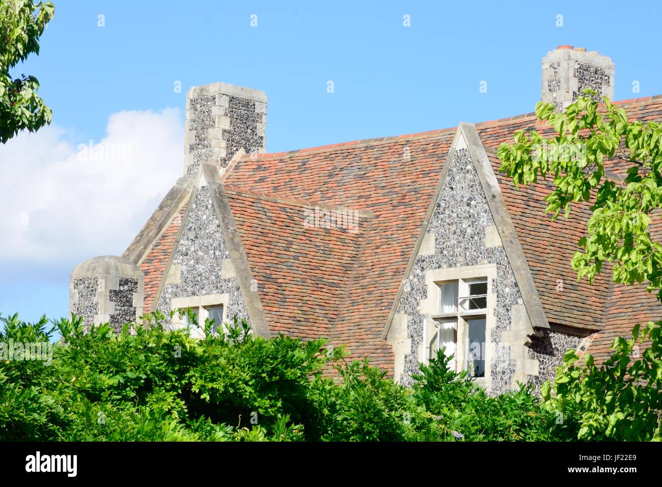 Large stone cottage behind trees Stock Photo - Alamy