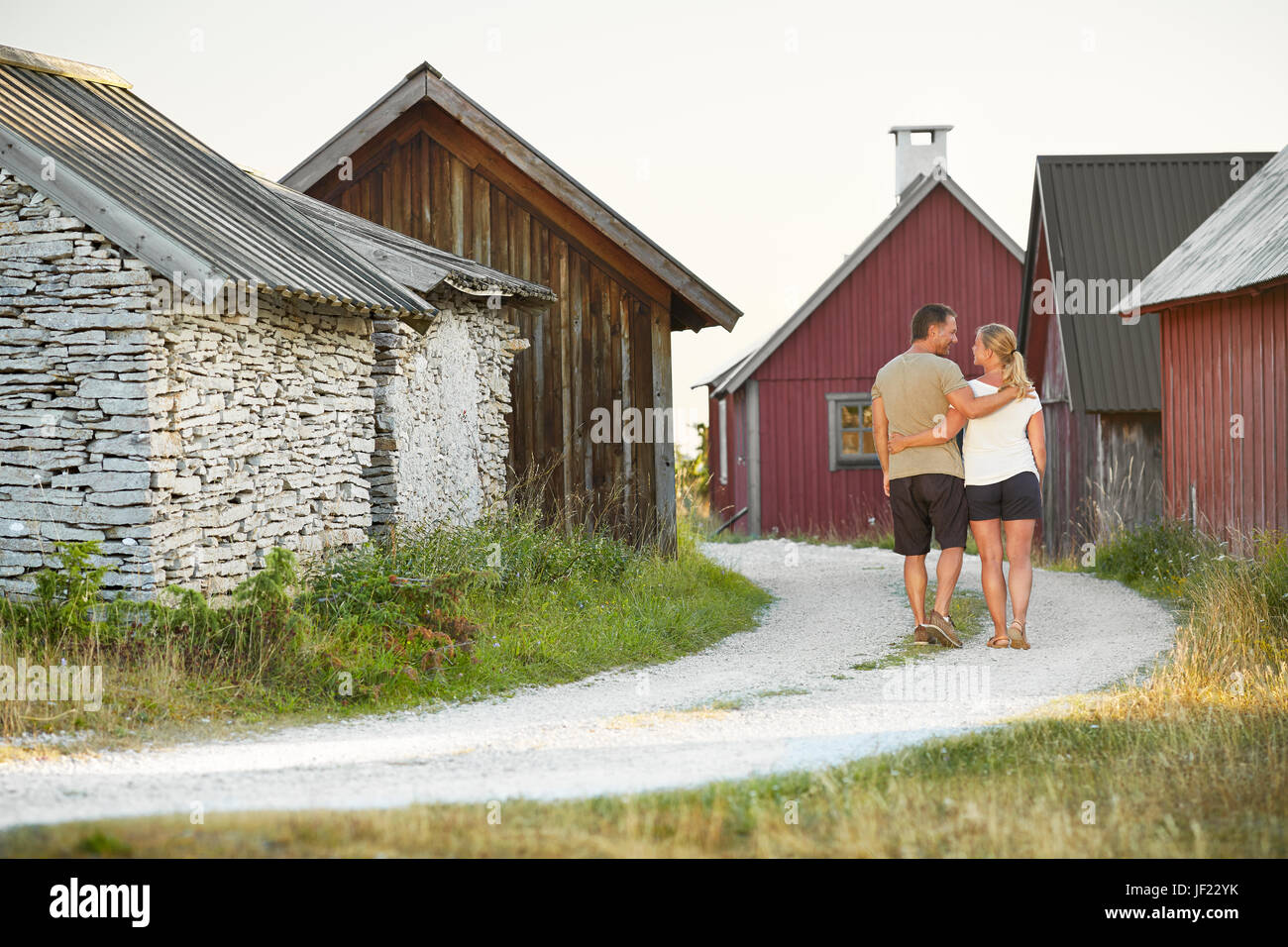 Couple walking through village Stock Photo - Alamy