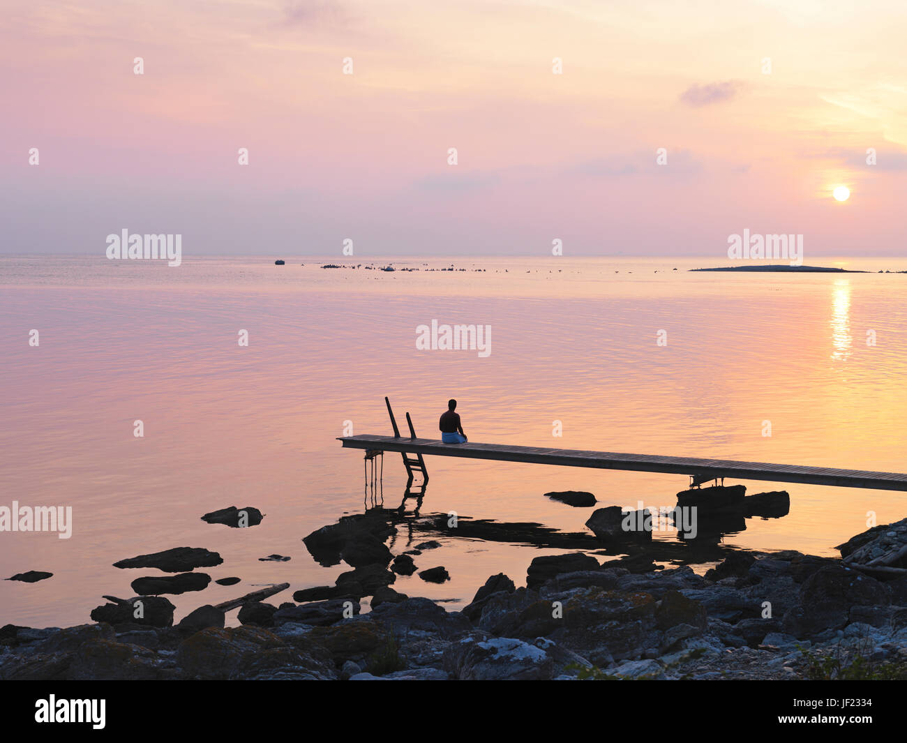 Silhouette people sitting on jetty hi-res stock photography and images ...