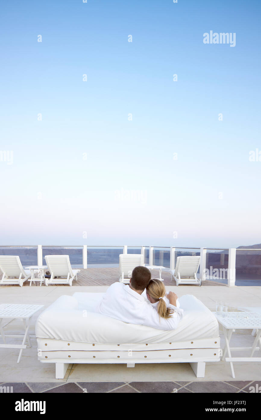 Couple hugging on sun bed Stock Photo - Alamy