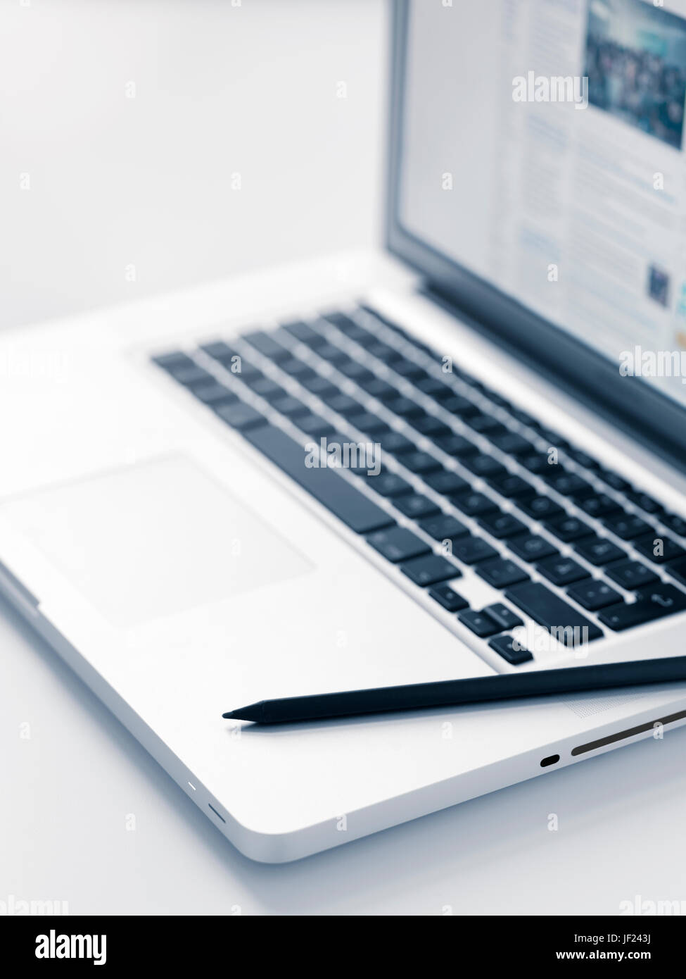 Pencil on laptop Stock Photo - Alamy