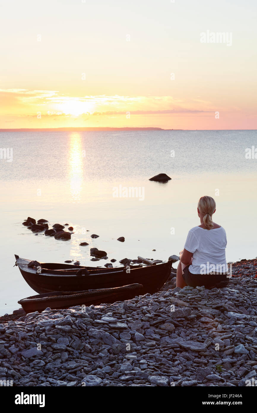 Woman looking at sunset Stock Photo - Alamy