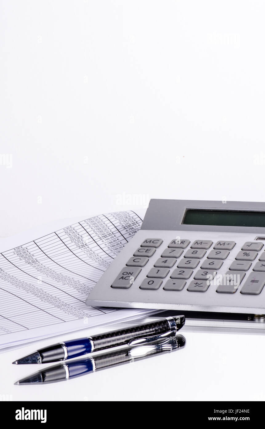 desk with pen and calculator, white background Stock Photo - Alamy