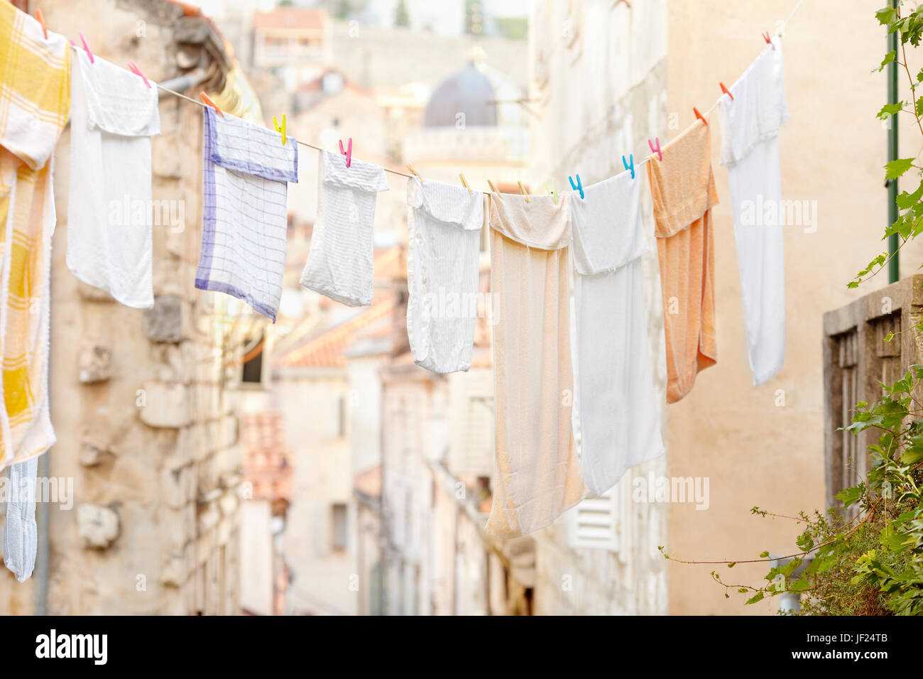 Laundry drying above street Stock Photo - Alamy