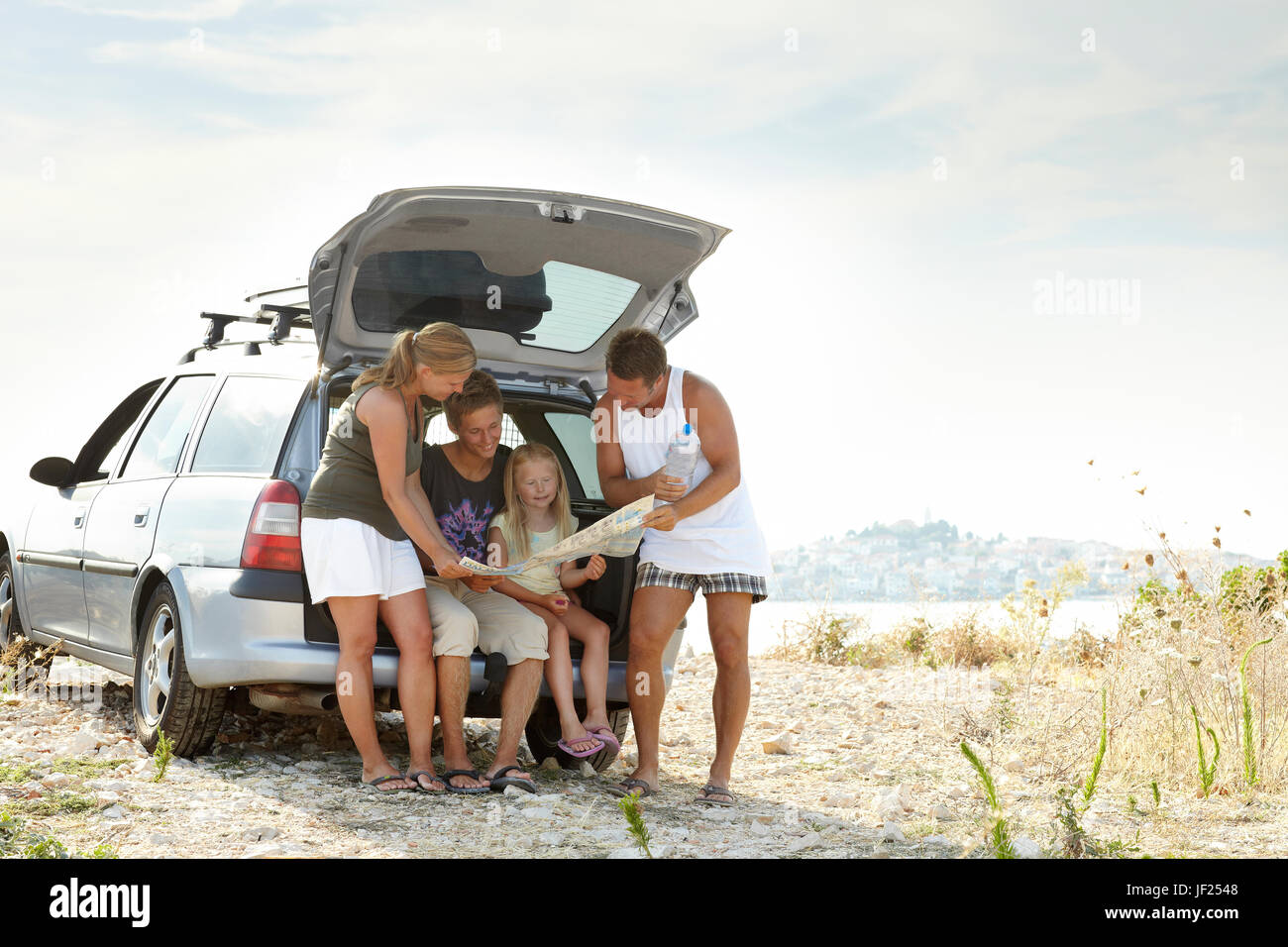 Family looking at map Stock Photo - Alamy