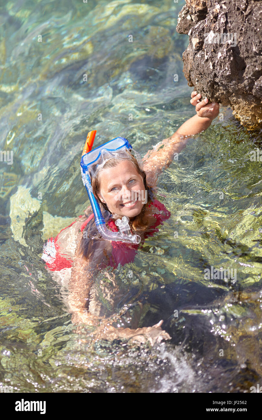 Smiling woman swimming Stock Photo - Alamy