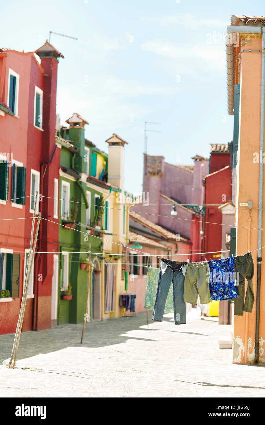 Laundry hanging across street Stock Photo - Alamy