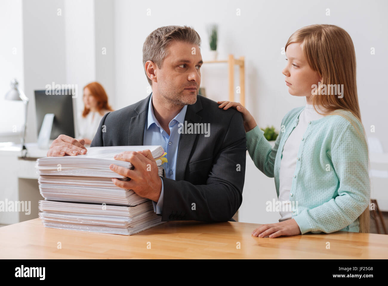 Diligent productive man loaded with assignments Stock Photo - Alamy