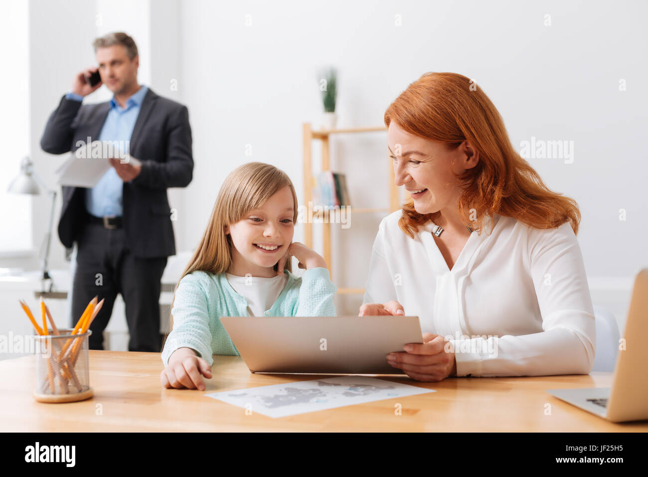 Lovely dedicated woman explaining how she working Stock Photo - Alamy