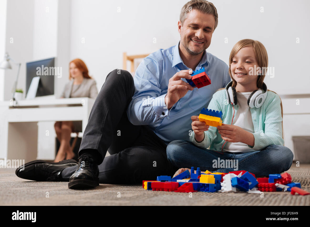 Excited bright family having fun in the office Stock Photo - Alamy