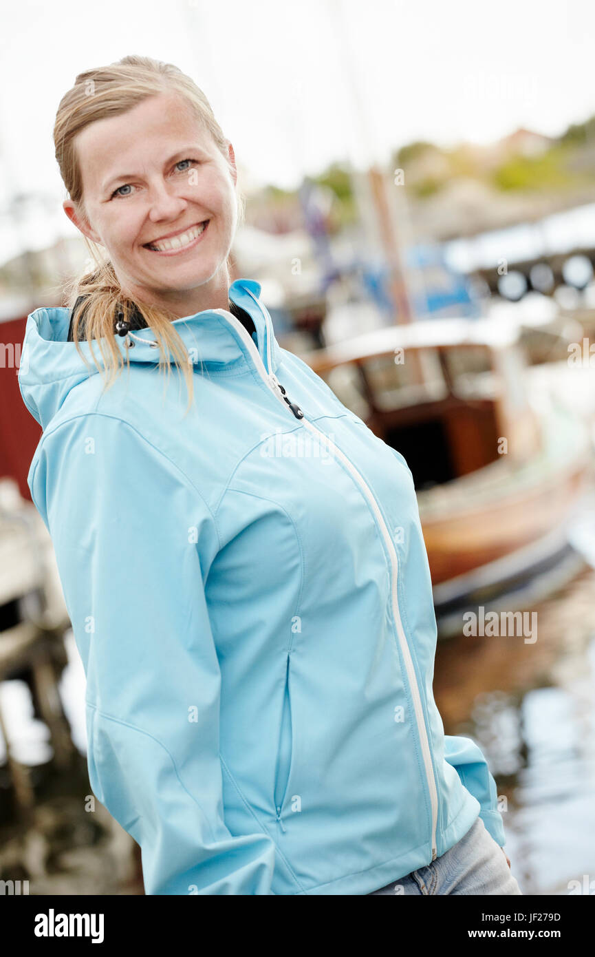 Smiling woman at water Stock Photo - Alamy